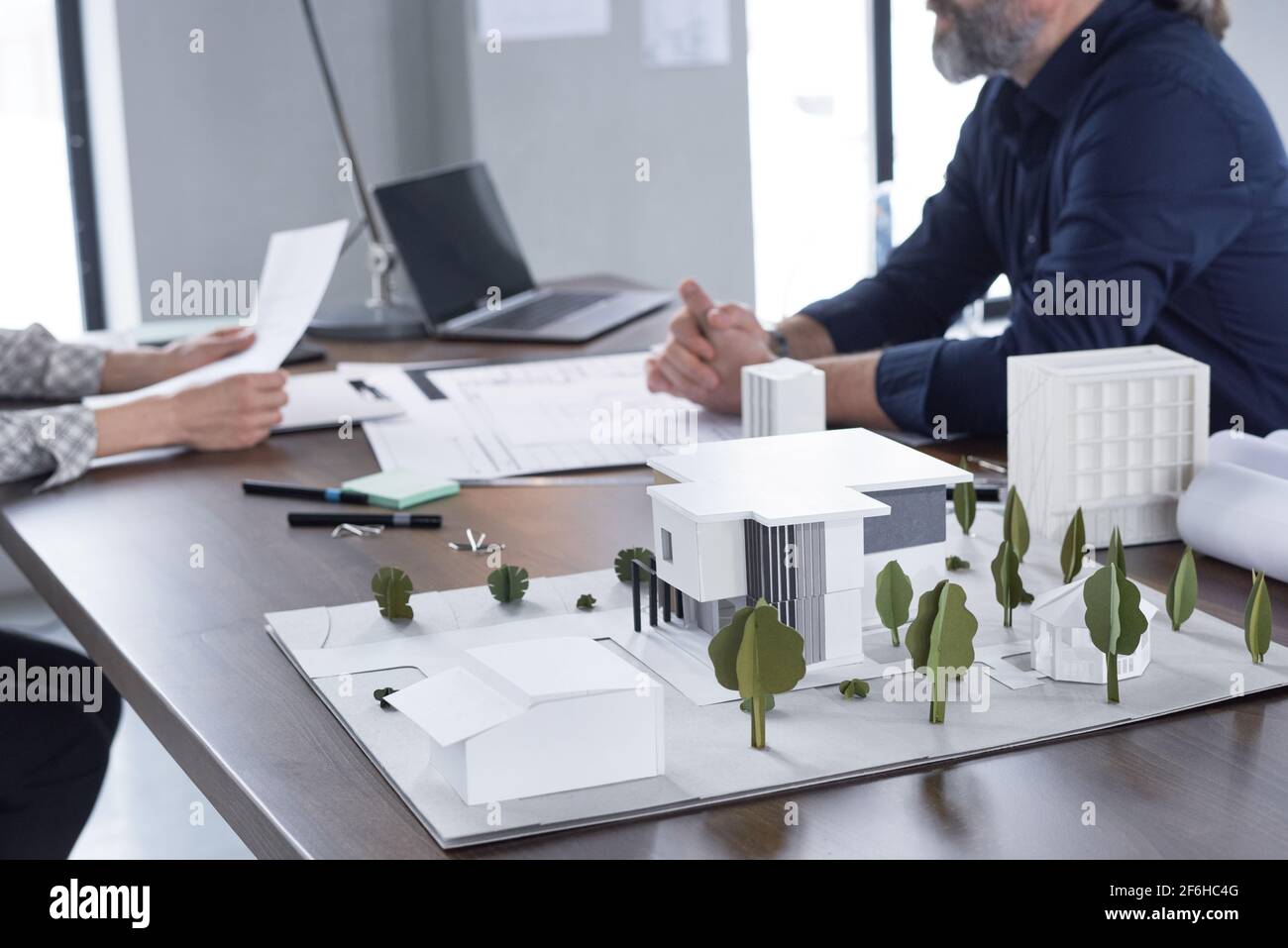 Image of little architectural model on the table with architects ...