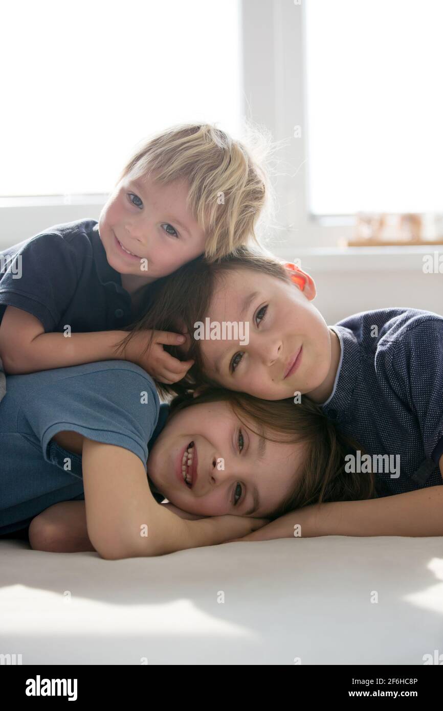 Three beautiful children, boy brothers, having family portrait, hugging ...