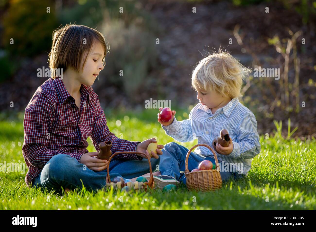 Cute children, eating chocolate bunnies and fighting with easter eggs ...
