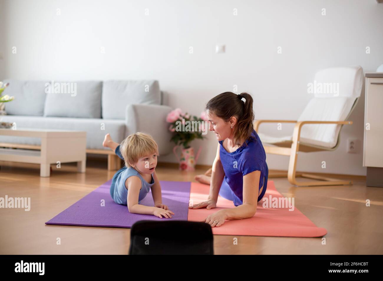 Mother and children, exercising at home during coronavirus, people ...