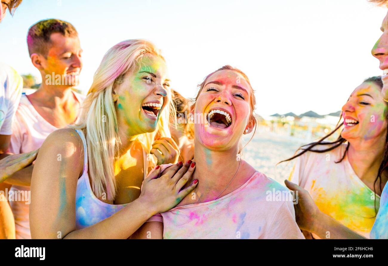 Happy friends group having fun at beach party on holi festival summer ...