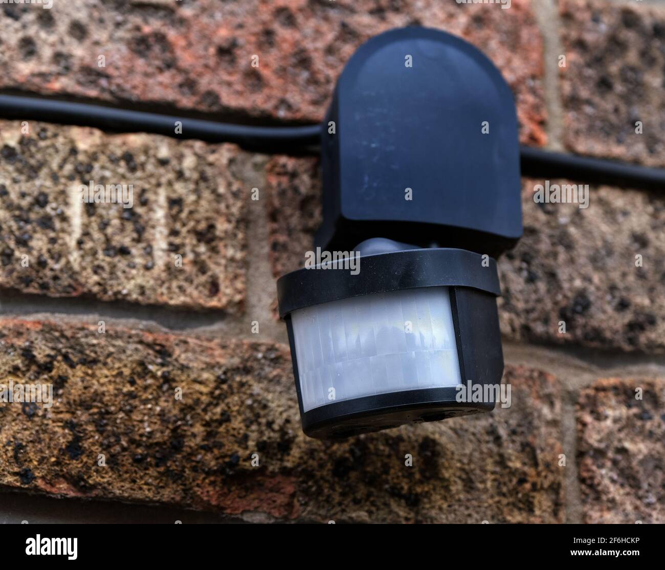 Infra red movement sensor to trigger security lighting Stock Photo - Alamy