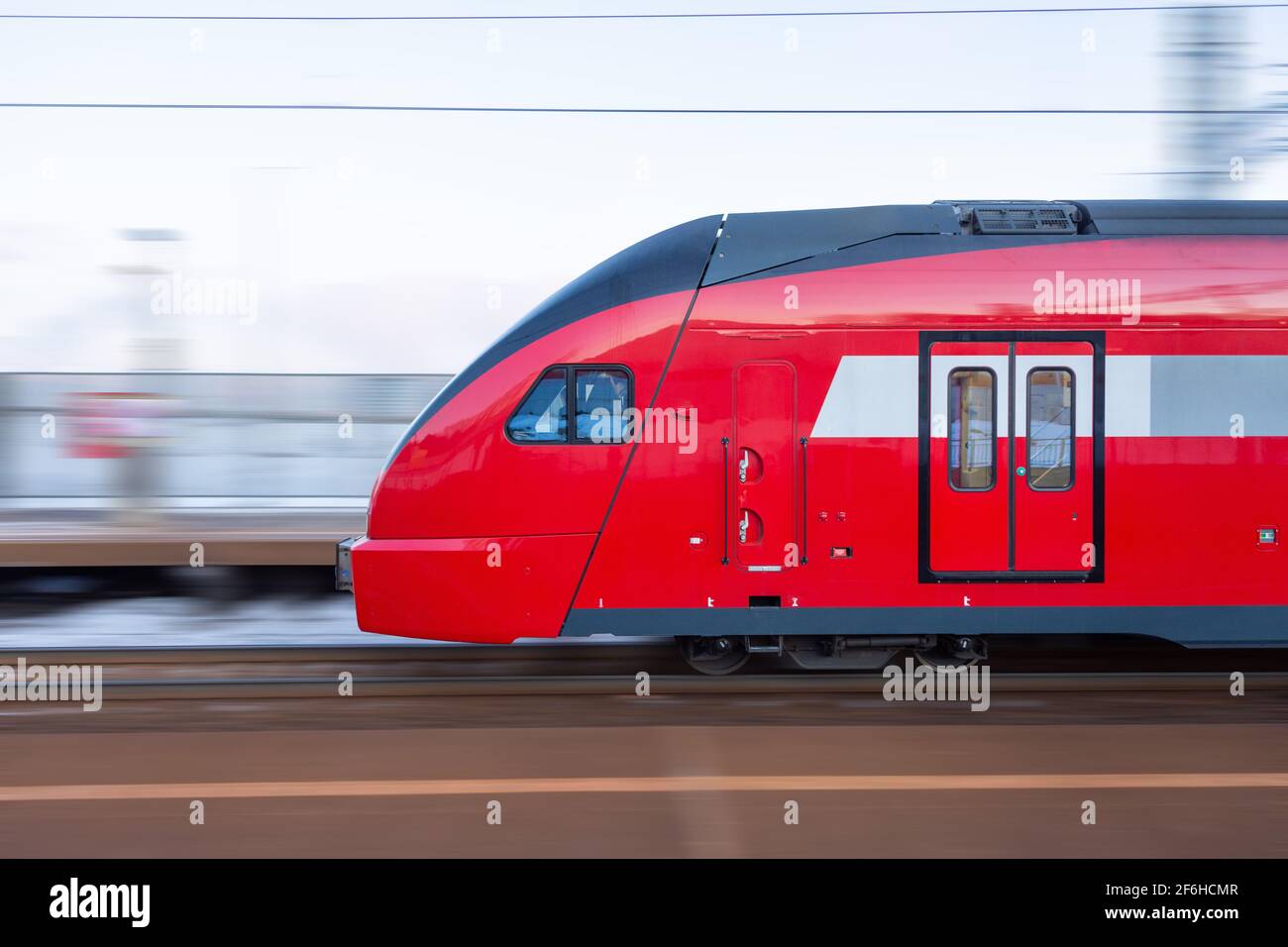Suburban train passing at high speed, side view Stock Photo - Alamy