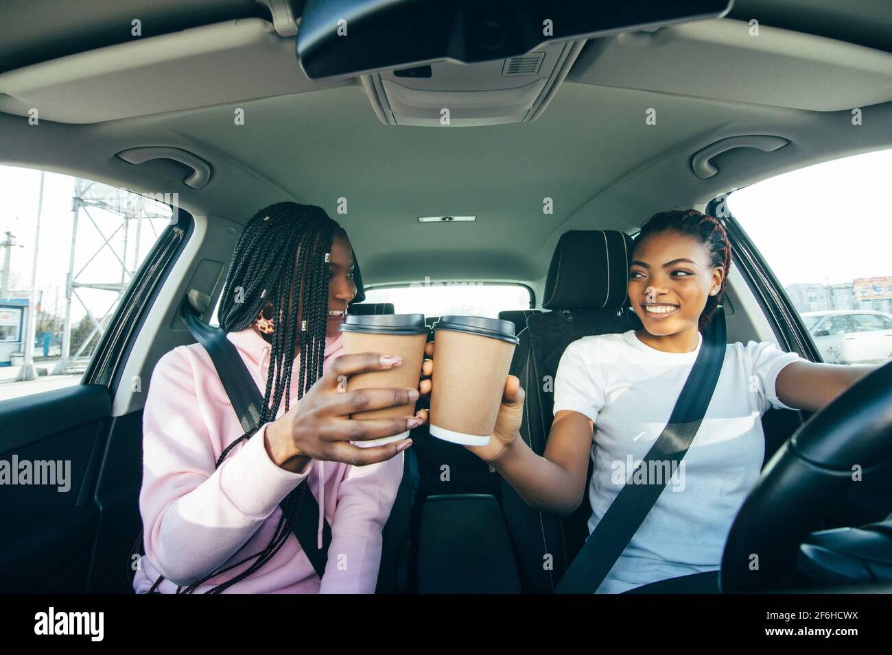 Happy friends with cup of coffee in car. Holiday trip of friends Stock ...