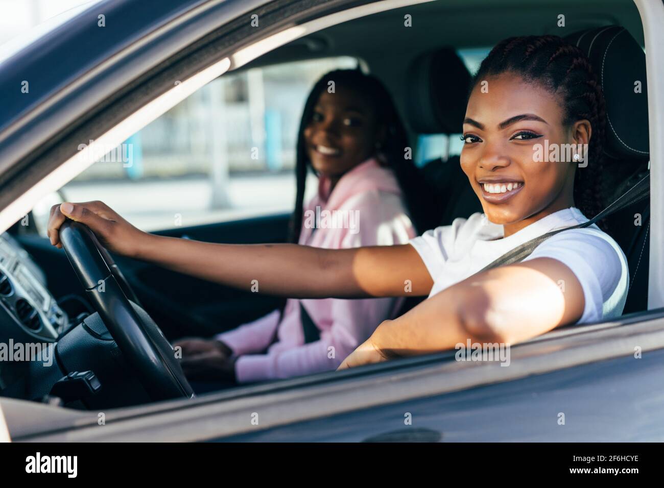 Two Female Friends On Road Trip Driving In Convertible Car Stock Photo ...