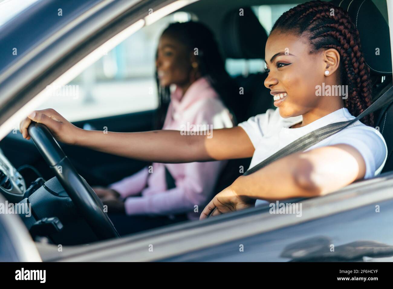Two Female Friends On Road Trip Driving In Convertible Car Stock Photo ...
