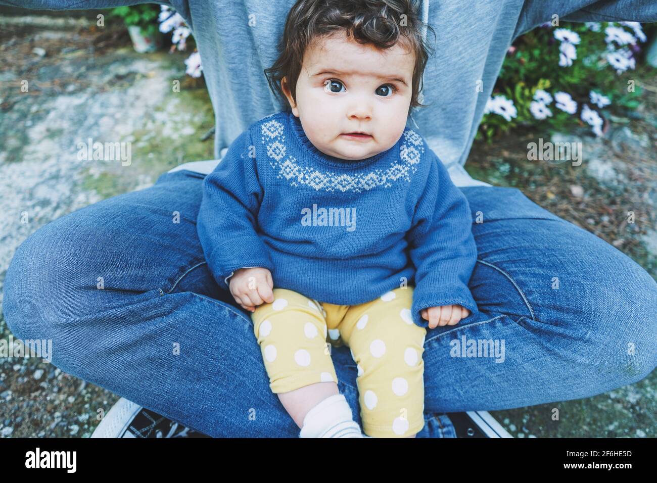Little baby portrait sitting on his dad legs Stock Photo - Alamy