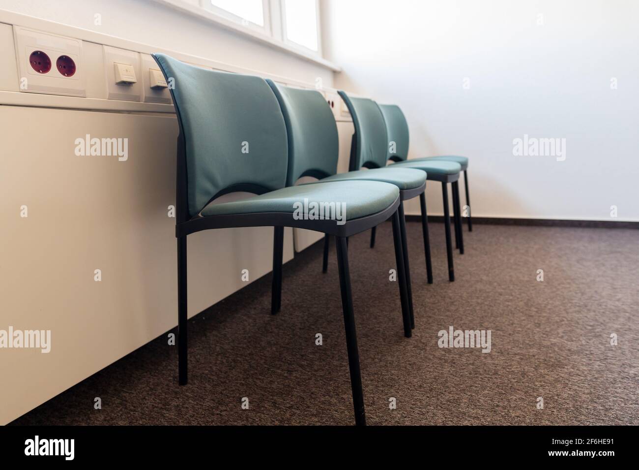 Chairs arranged in a row Stock Photo - Alamy