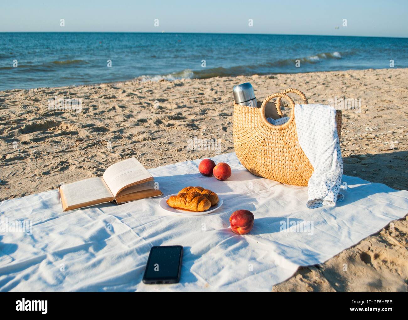 Cozy atmospheric picnic at the seaside with fresh croissants and an ...