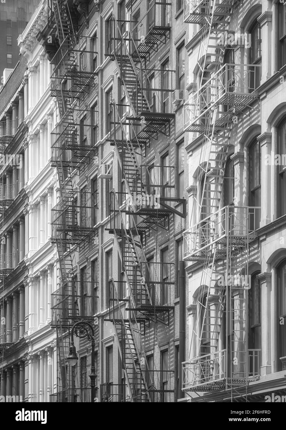 Row of old buildings with iron fire escapes, black and white picture ...