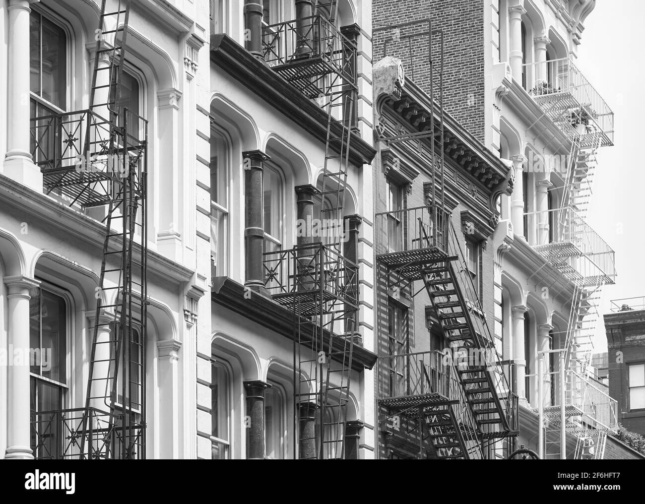 Row of old buildings with iron fire escapes, black and white picture ...