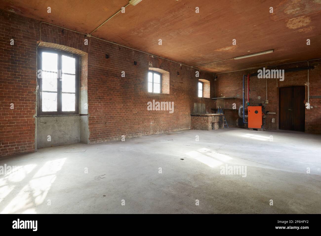 Old workshop interior with brick walls and windows, sunlight Stock ...