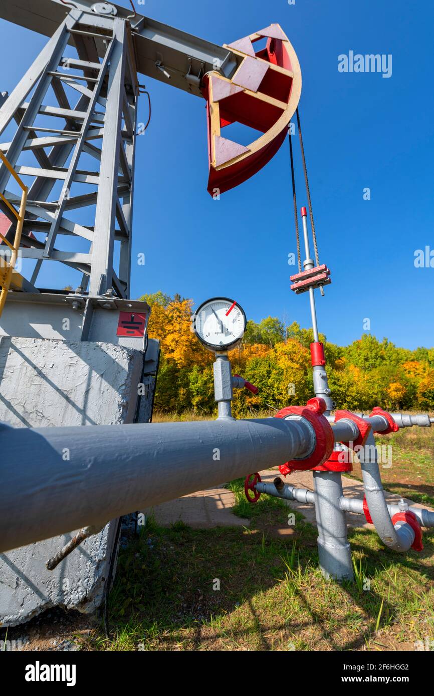 Oil pressure gauge shows 10 ATM. Oil pumpjack. A pumpjack is the ...