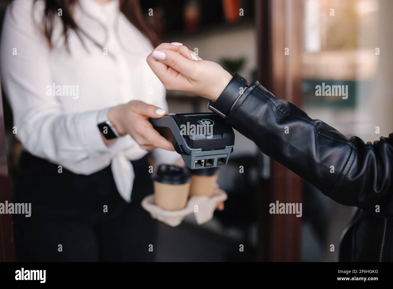 Close up of customer making wireless payment using smartwatch outside ...