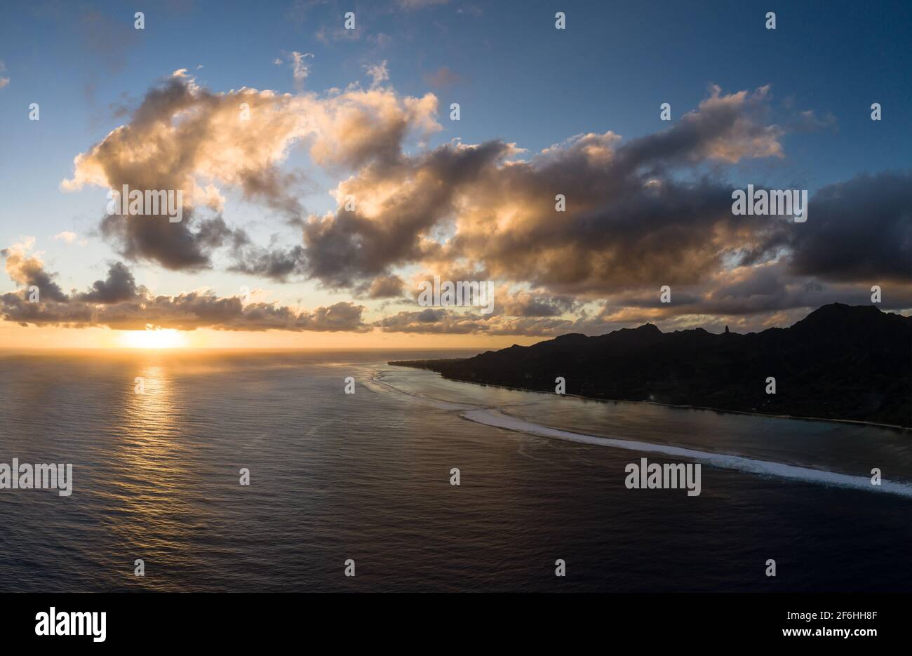 Dramatic aerial panorama of the sunset over the Rarotonga island, the ...