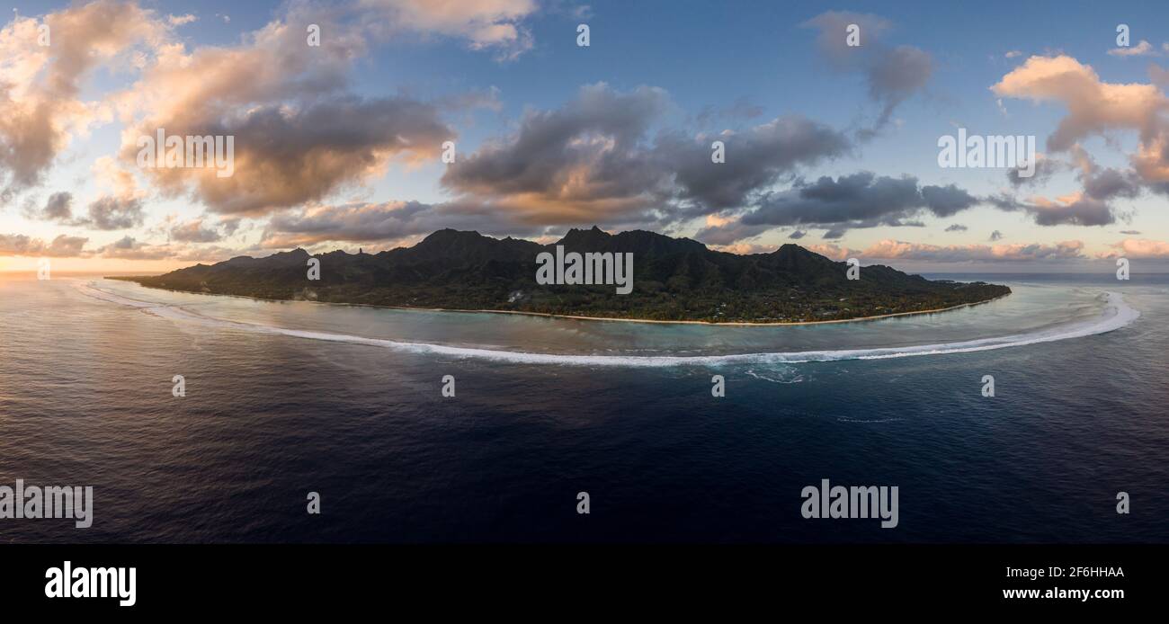 Dramatic aerial panorama of the sunset over the Rarotonga island, the ...