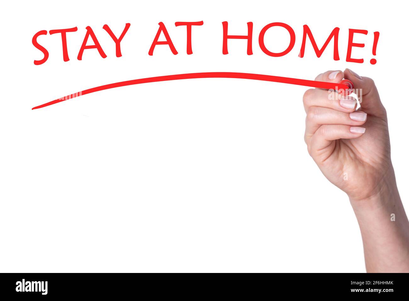Hand writes word stay at home with red marker on transparent white ...
