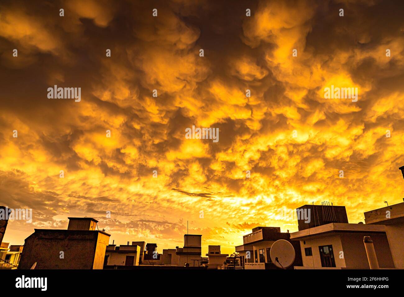 dramatic layered yellow with cumulus clouds over the building.abstract ...