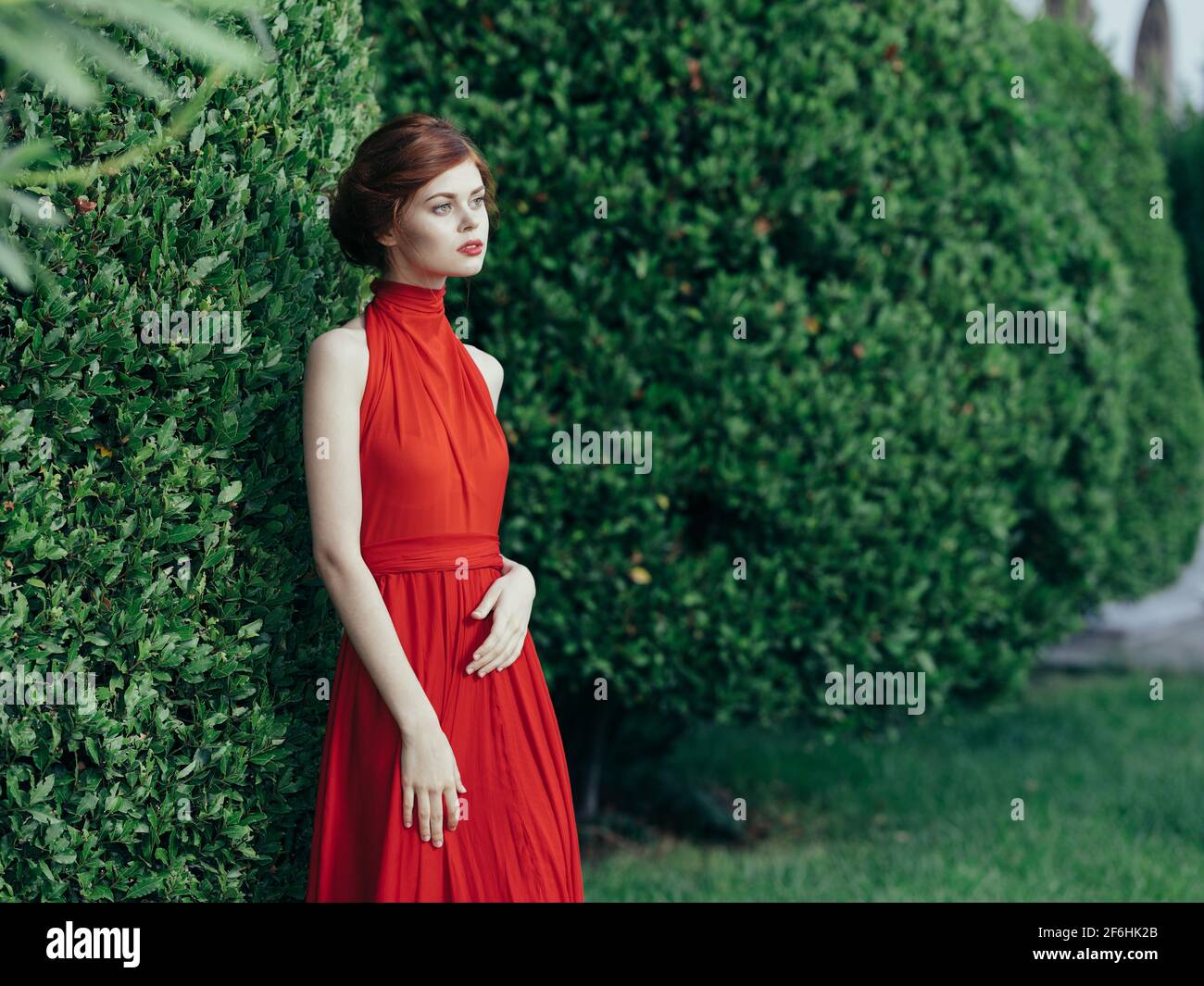 Beautiful lady red dress green bush outdoors walk luxury princess Stock ...