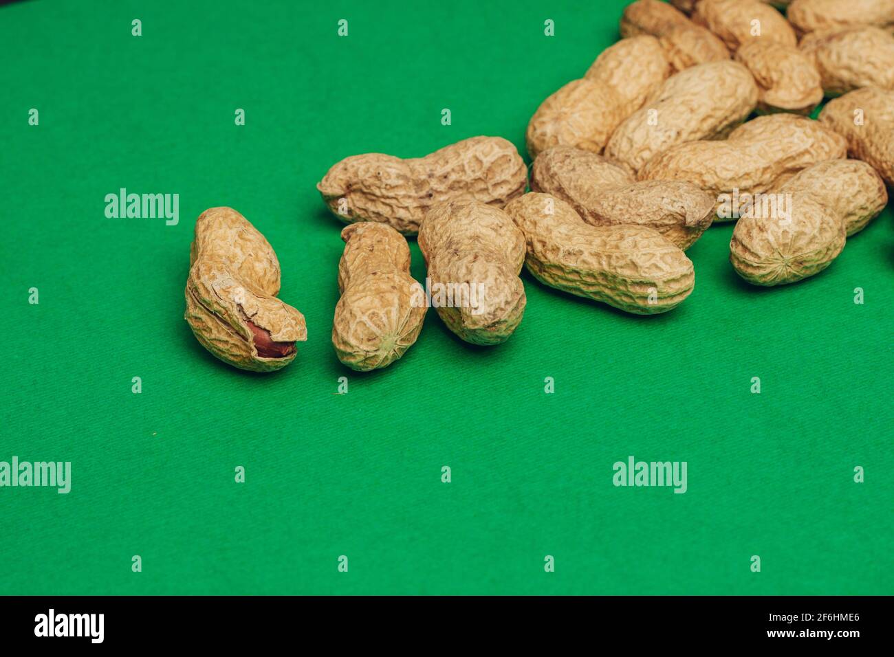 peanuts in shells snack Green background snack for alcohol Stock Photo ...