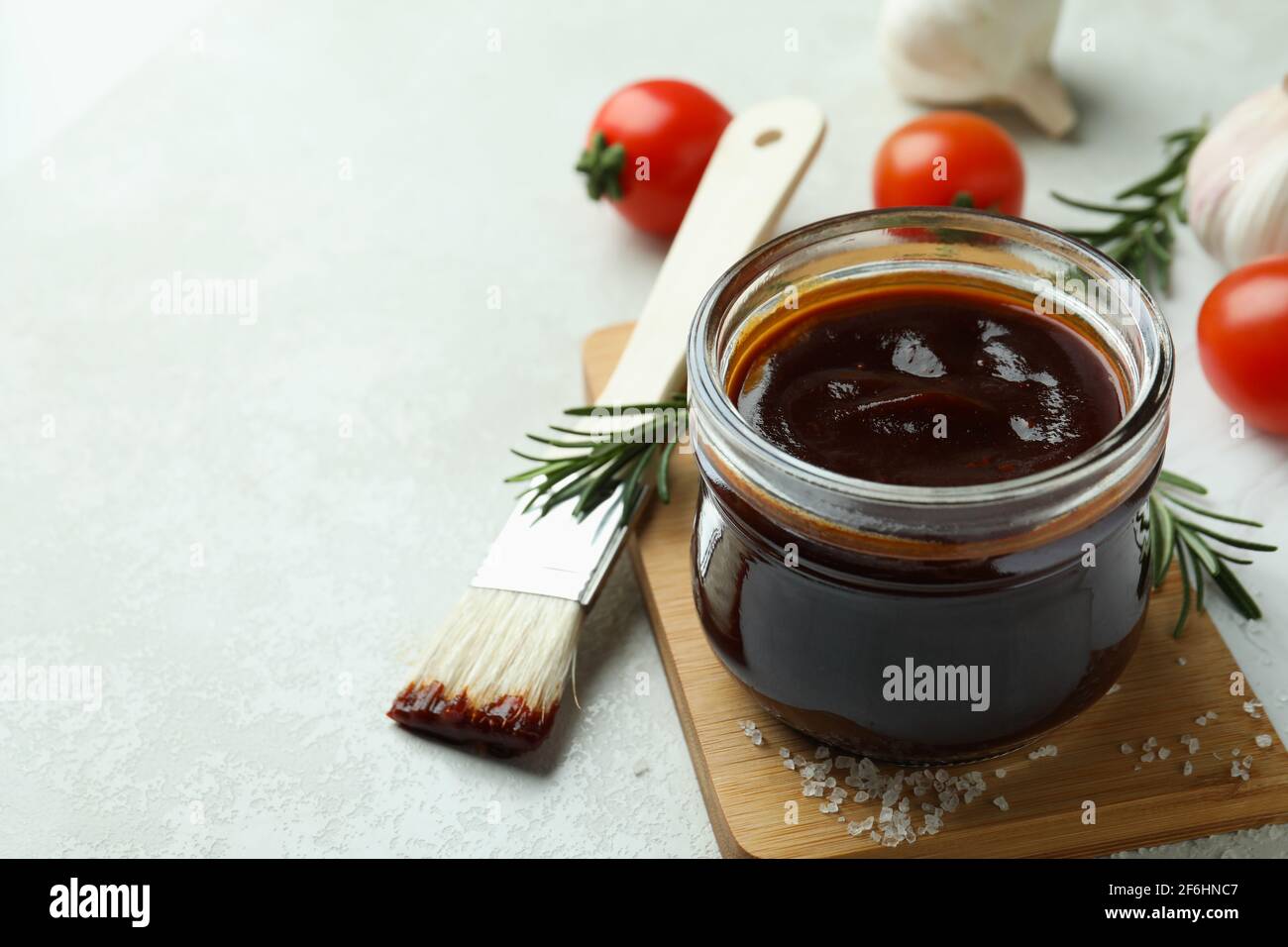 Concept of cooking with barbecue sauce on white textured table Stock ...