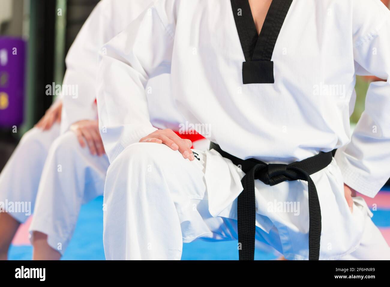 People in a gym in martial arts training exercising Taekwondo, the ...