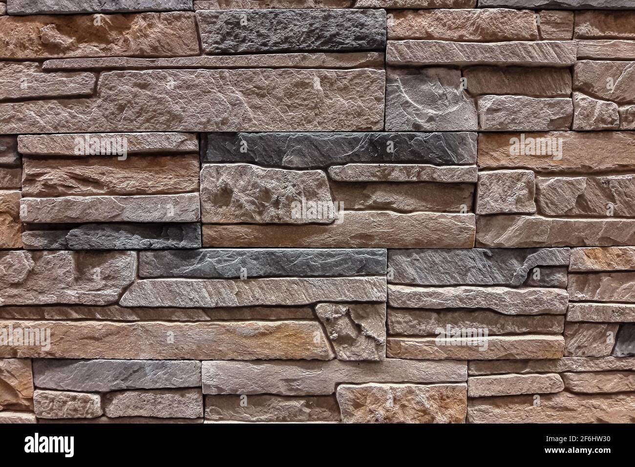 The wall is made of multi-layered natural stone. Stone for building a ...