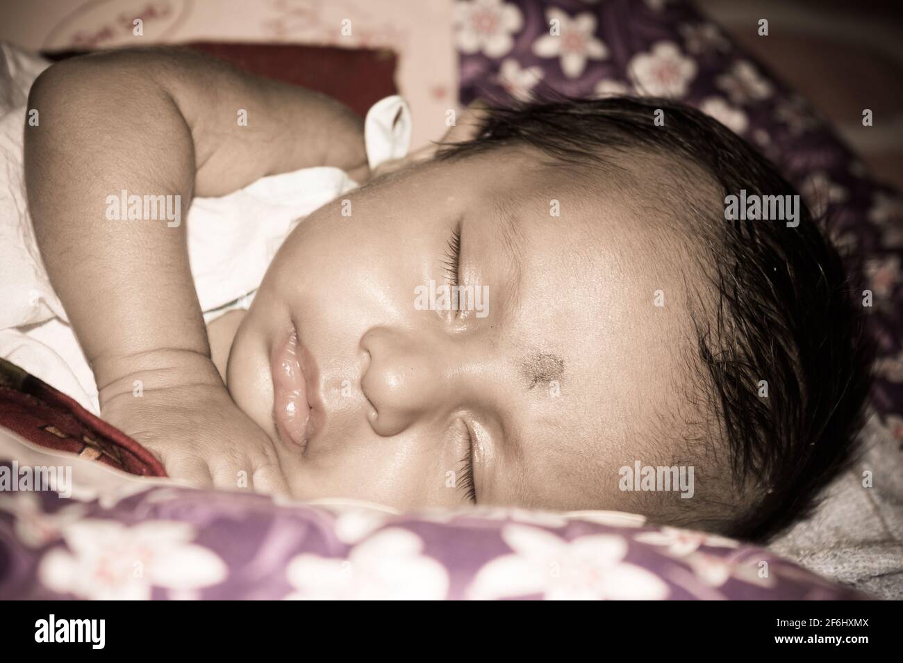 Close up face of a cute sleeping newborn baby. Closeup portrait of a ...