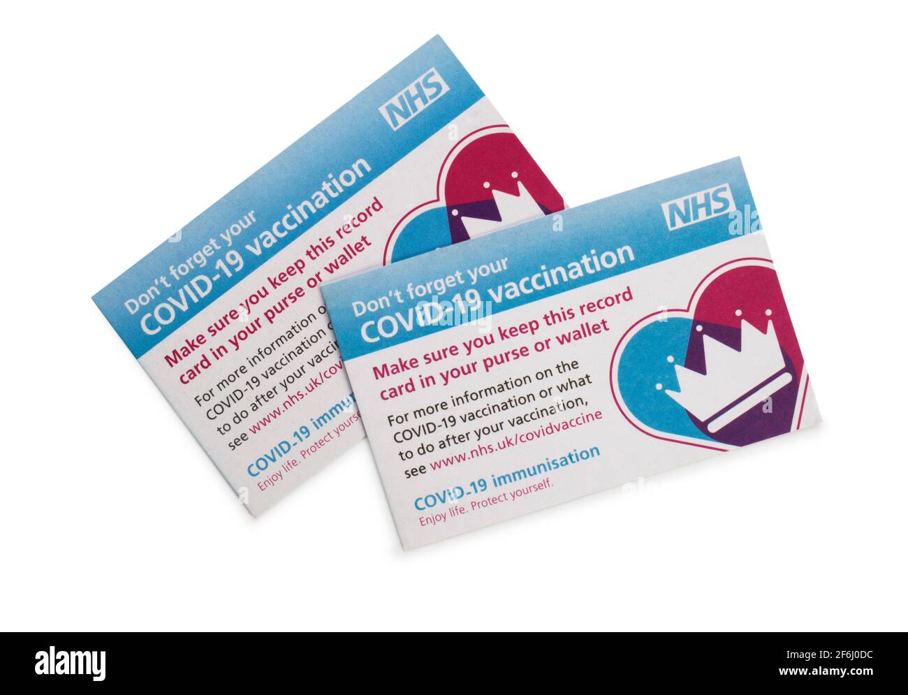 Studio shot of a NHS vaccination card cut out against a white ...