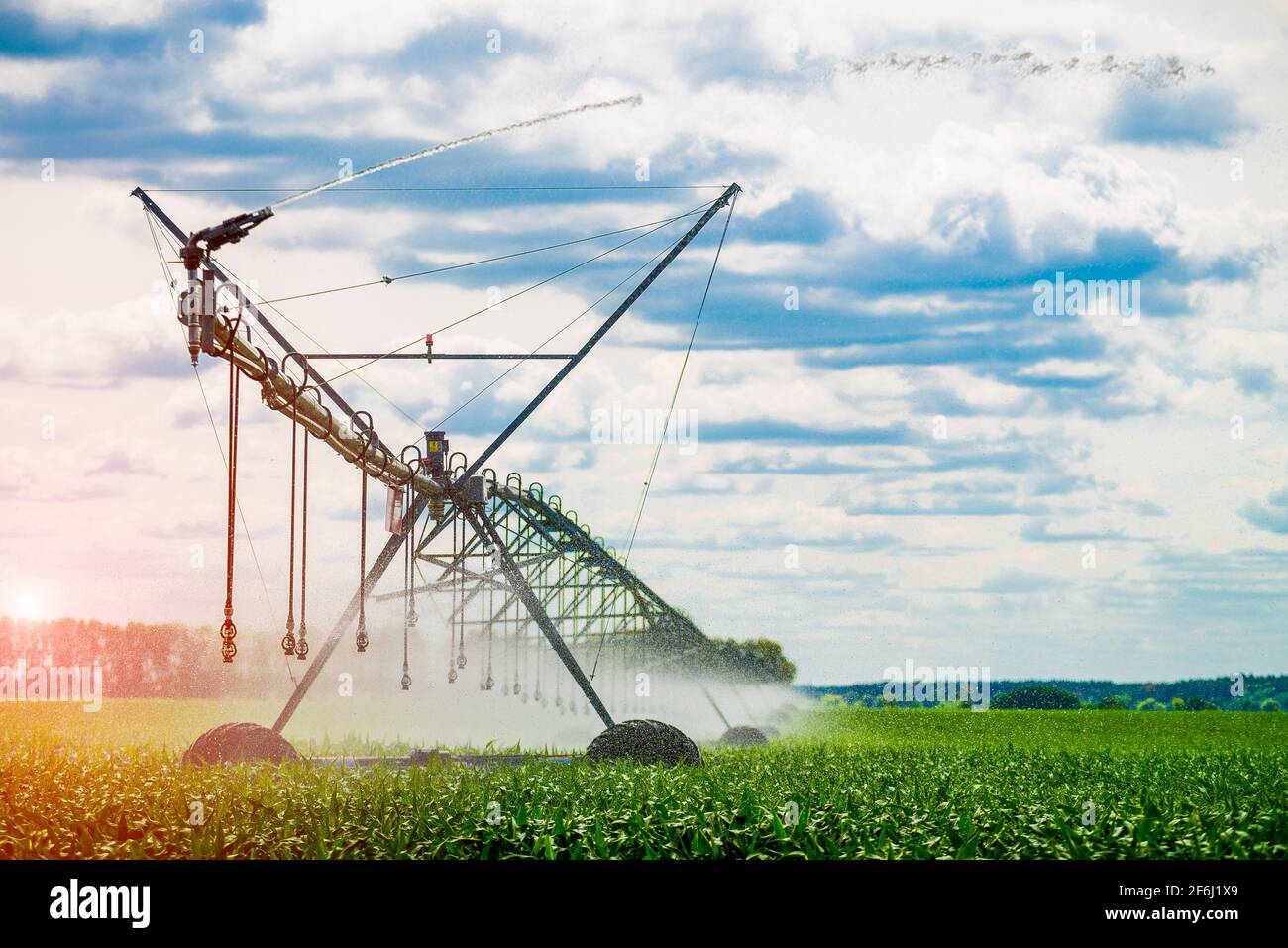 Watering system in the field. An irrigation pivot watering a field ...