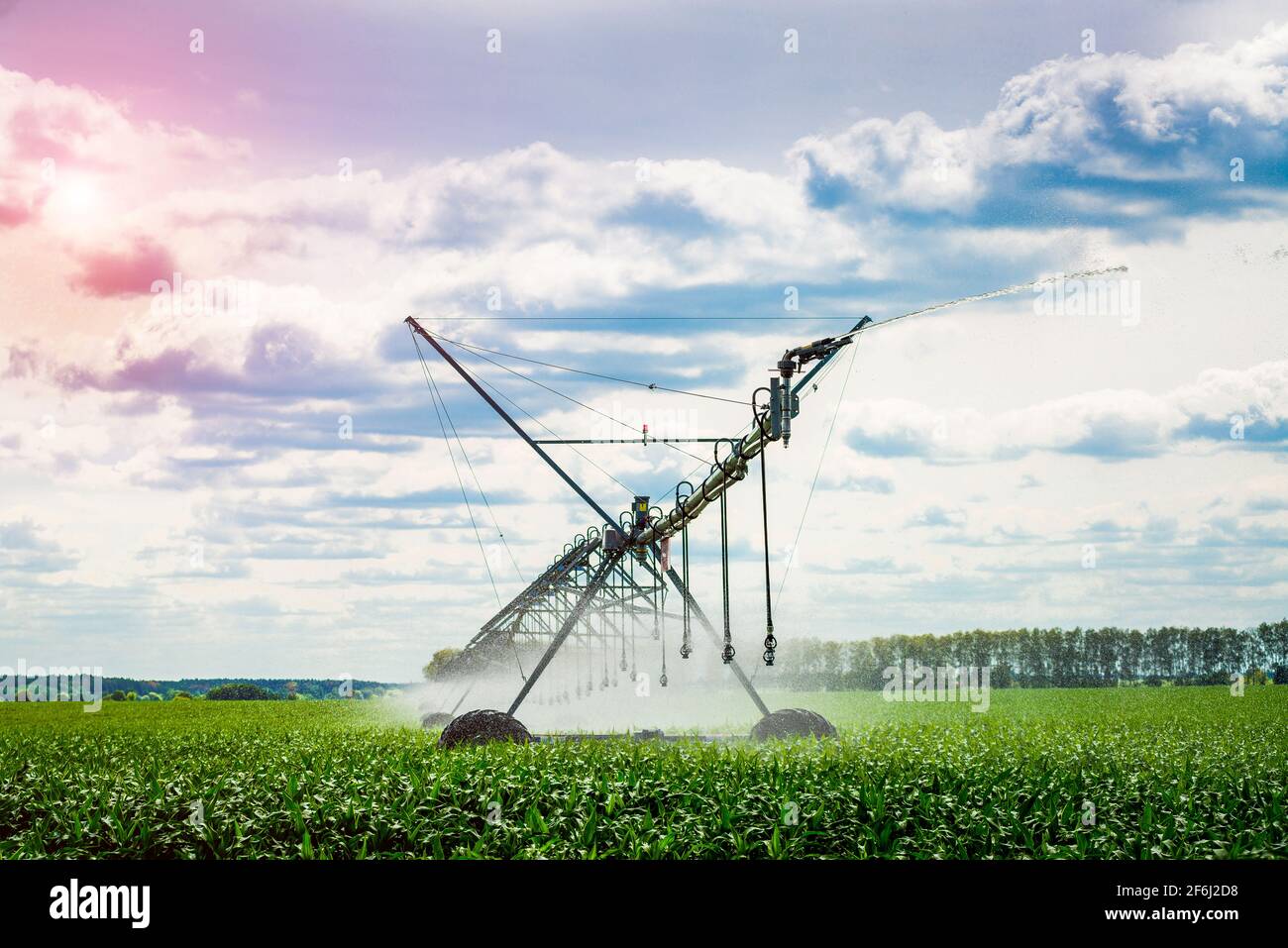 Watering system in the field. An irrigation pivot watering a field ...