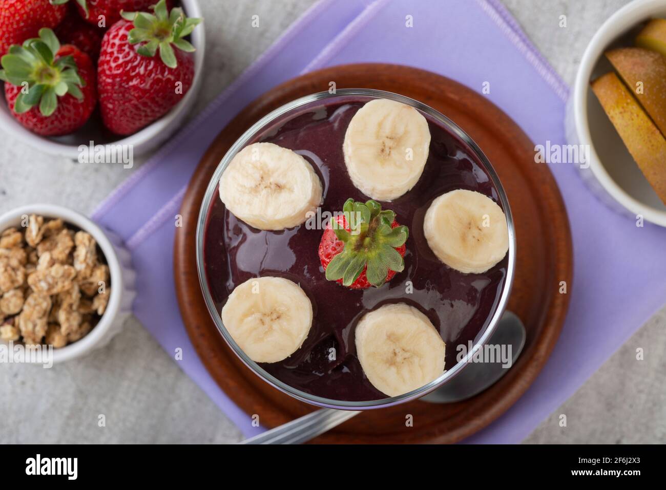 Brazilian typical acai bowl with fruits and muesli over wooden ...