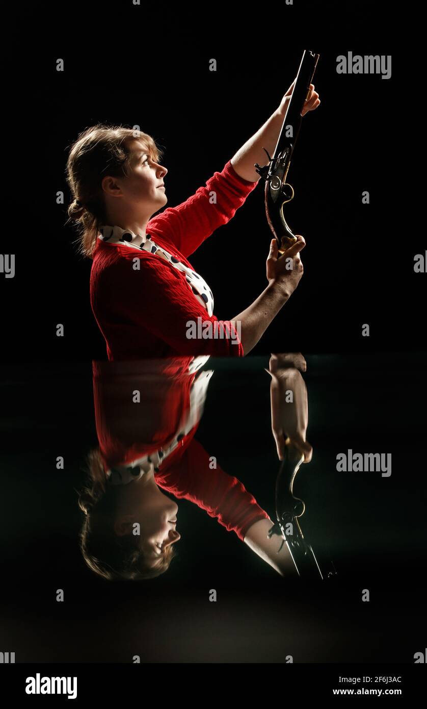 Tennants Auctioneers' employee Alice Fitton is reflected in a glass ...