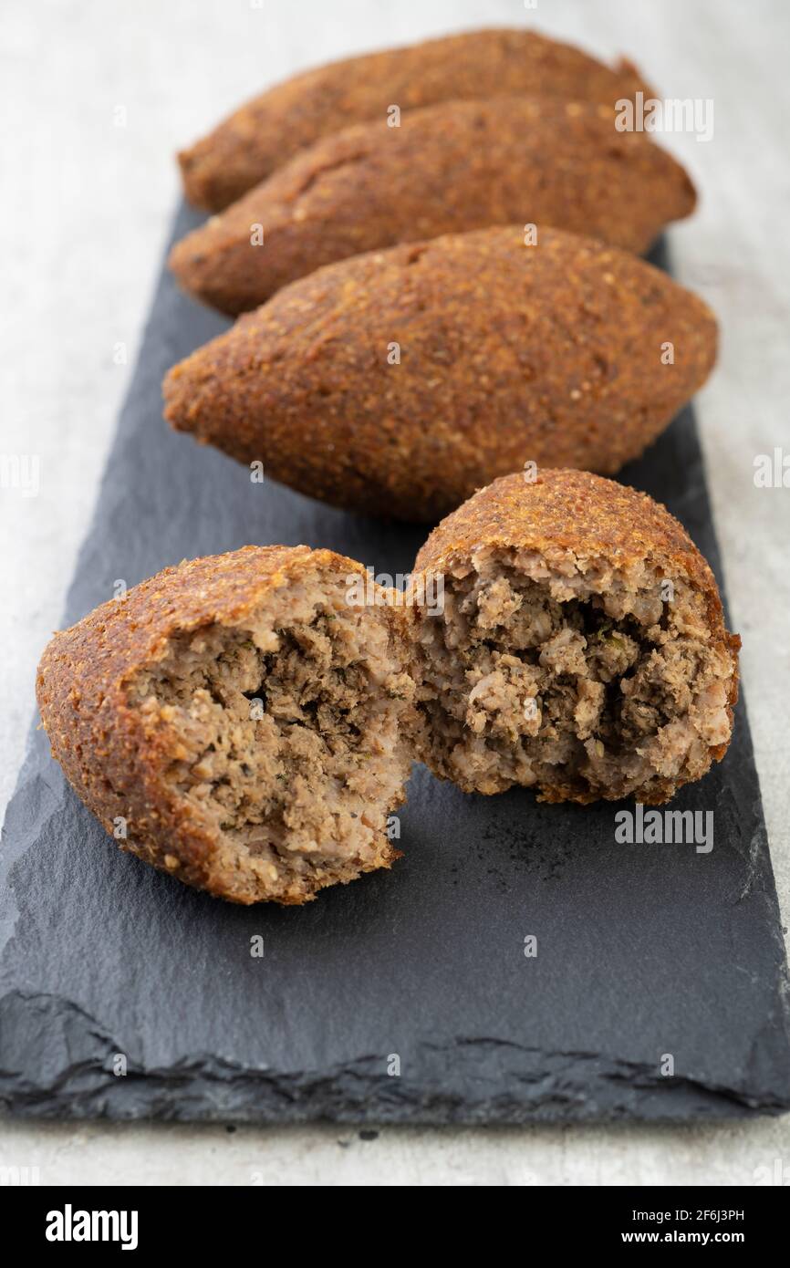 Traditional arabic fried kibbeh over stone board. Typical brazilian ...