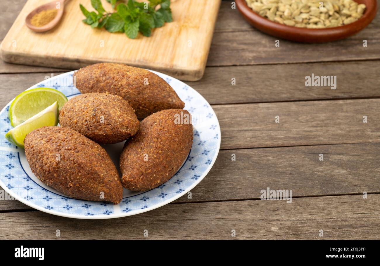 Traditional arabic fried kibbeh over wooden table with copy space ...