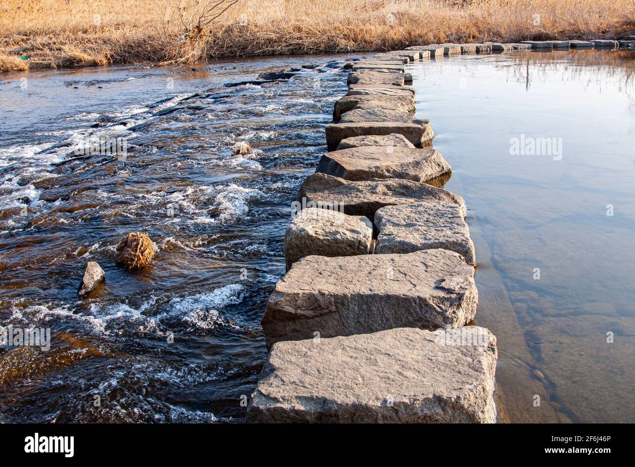 a river that flows vigorously between the river's stone bridges Stock ...