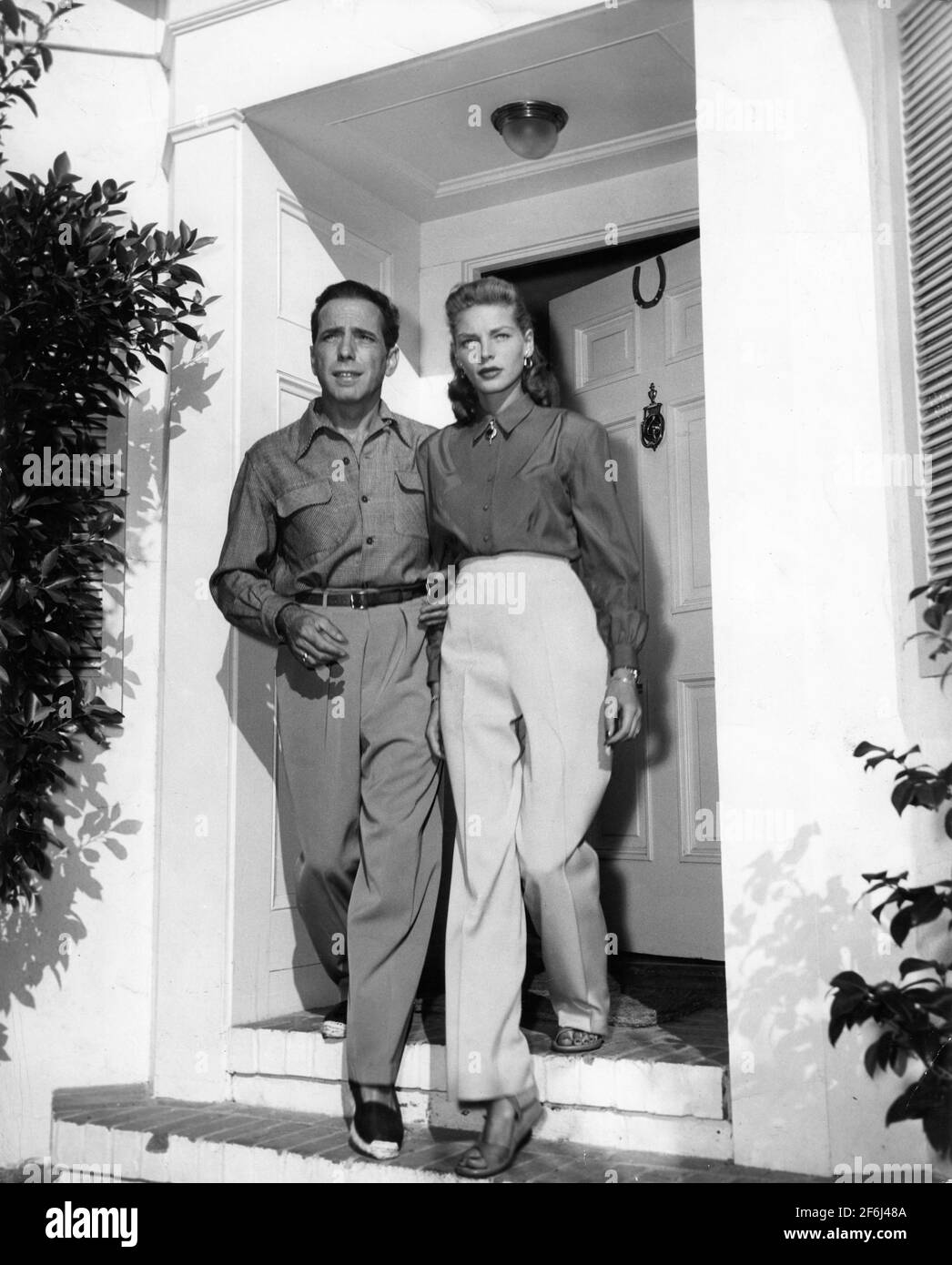 HUMPHREY BOGART and LAUREN BACALL at the front door of their Beverly ...