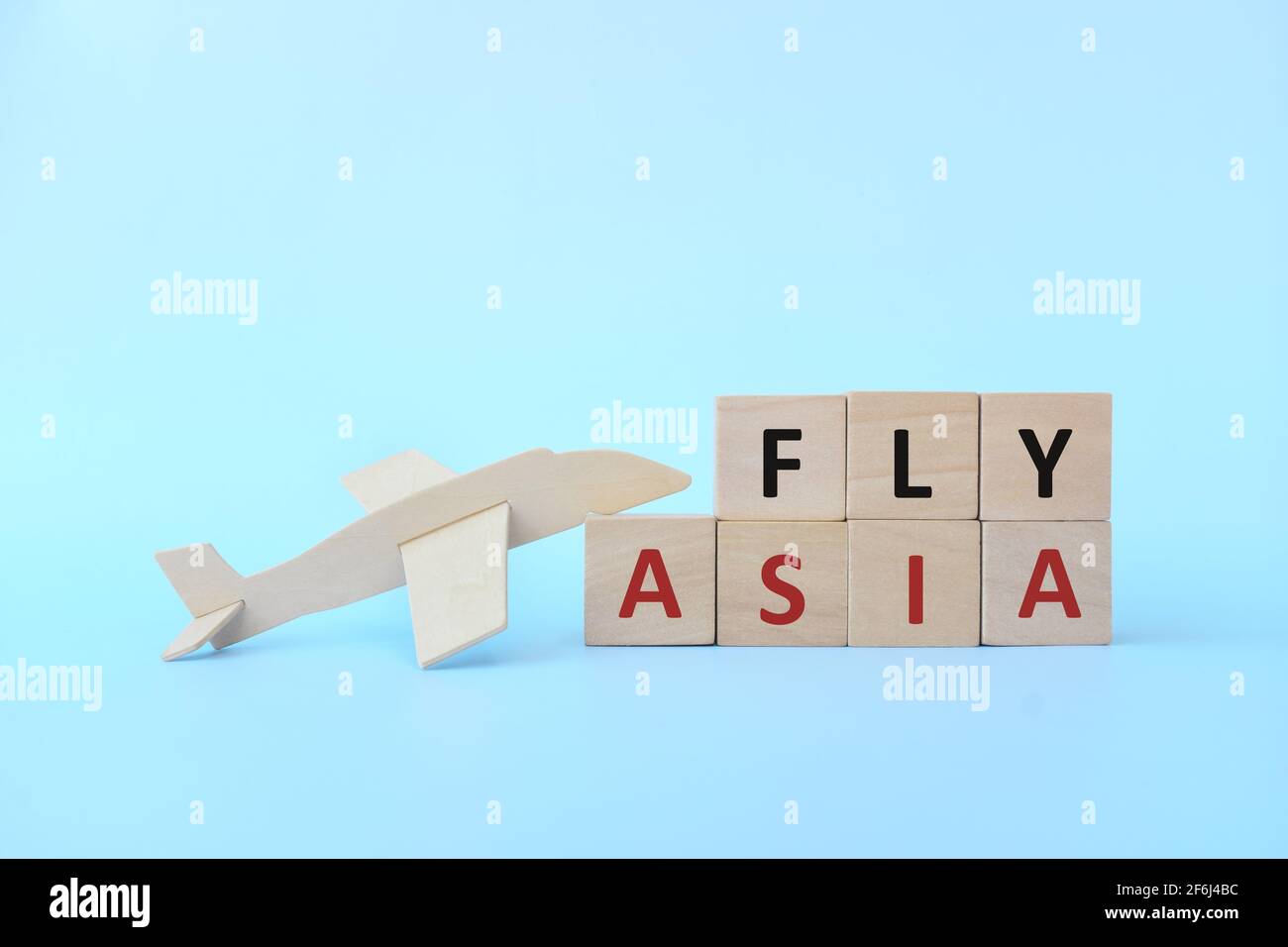 Airplane model and wooden blocks on blue background with copy space ...