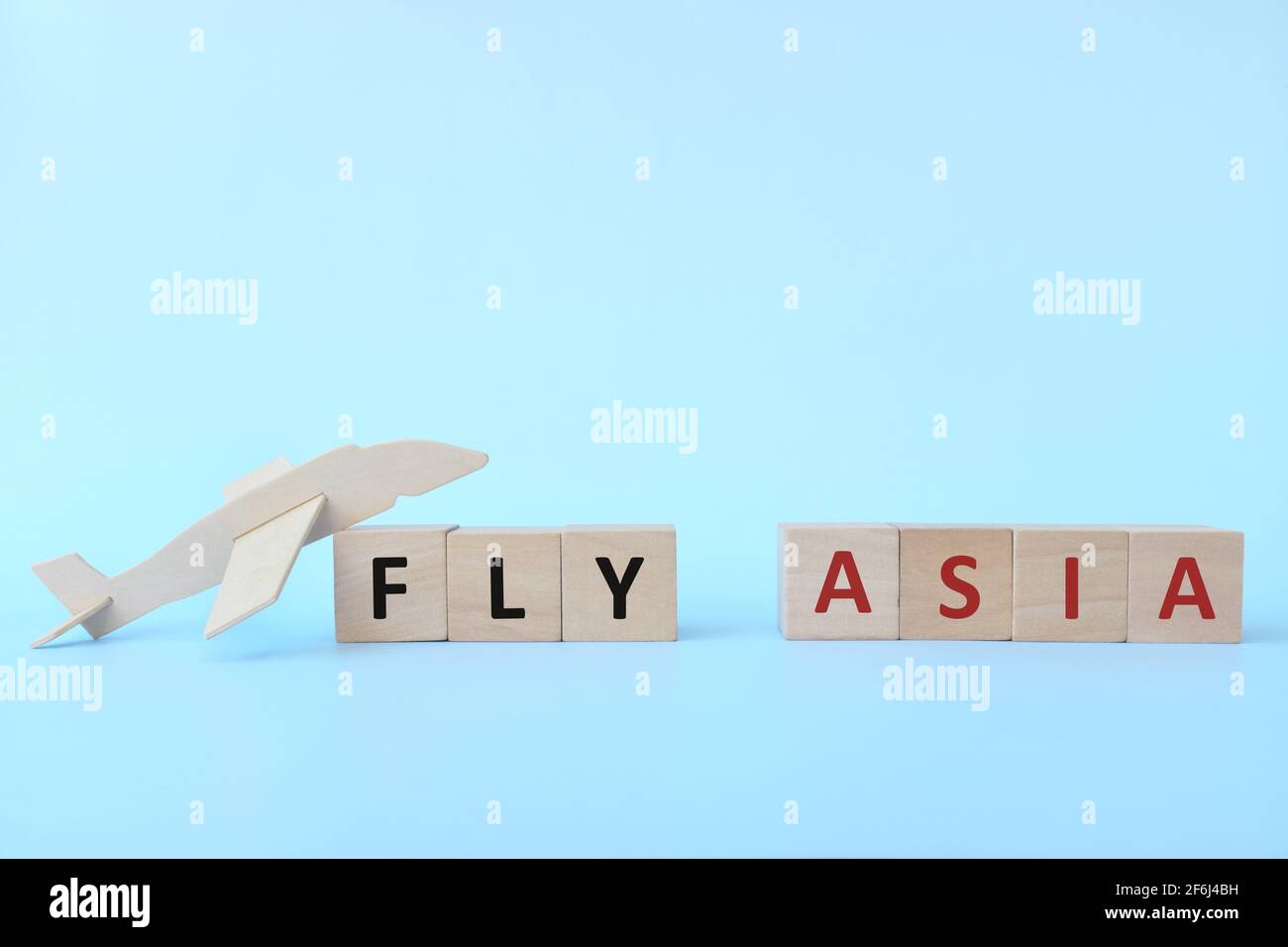 Airplane model and wooden blocks on blue background with copy space ...