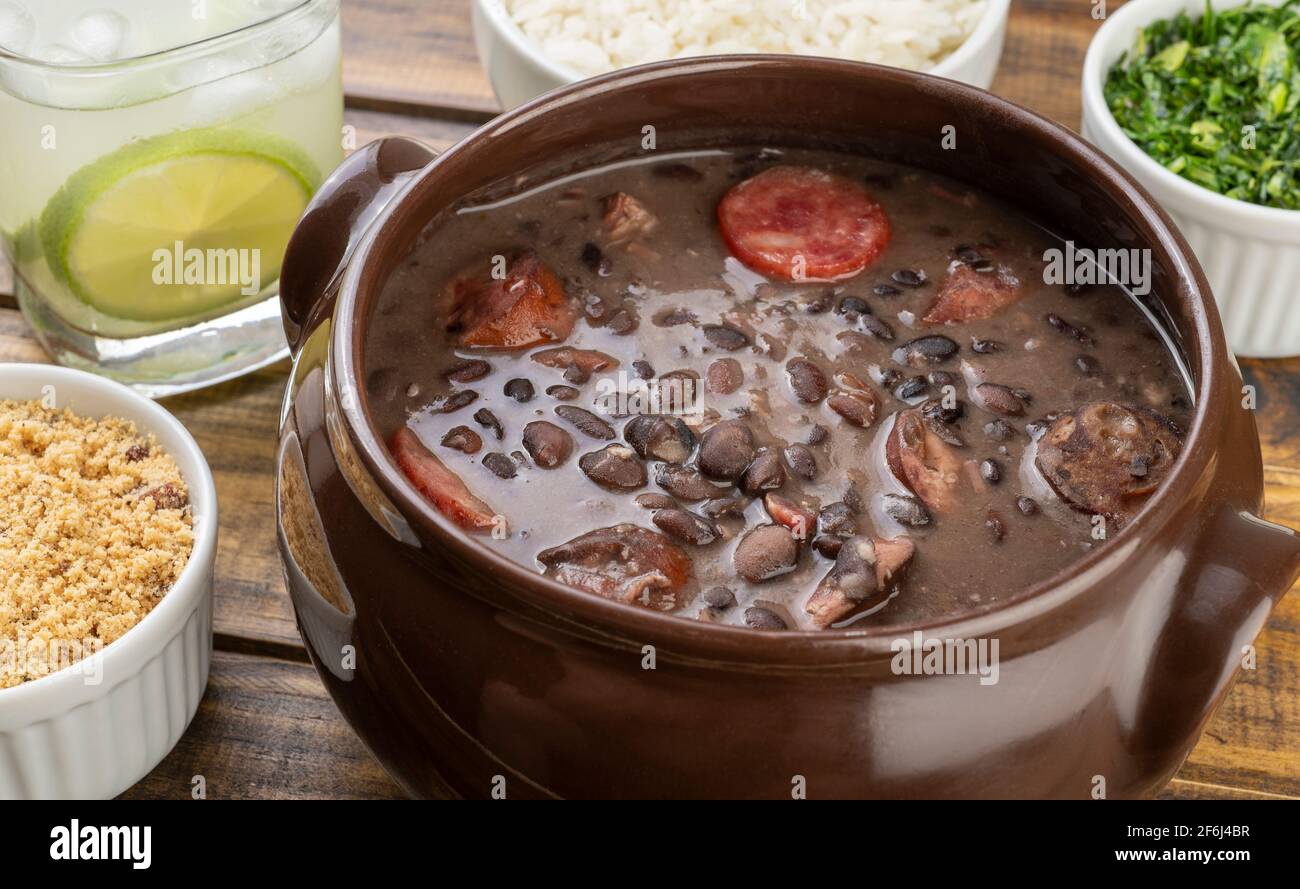 Traditional brazilian feijoada with kale, rice, manioc flour and ...