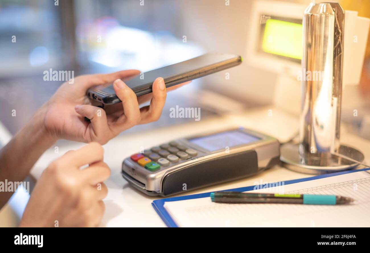 Customer making wireless or contactless payment using smartphone scan ...