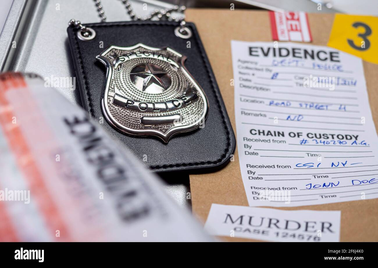 Police badge next to evidence bag, concept image Stock Photo - Alamy