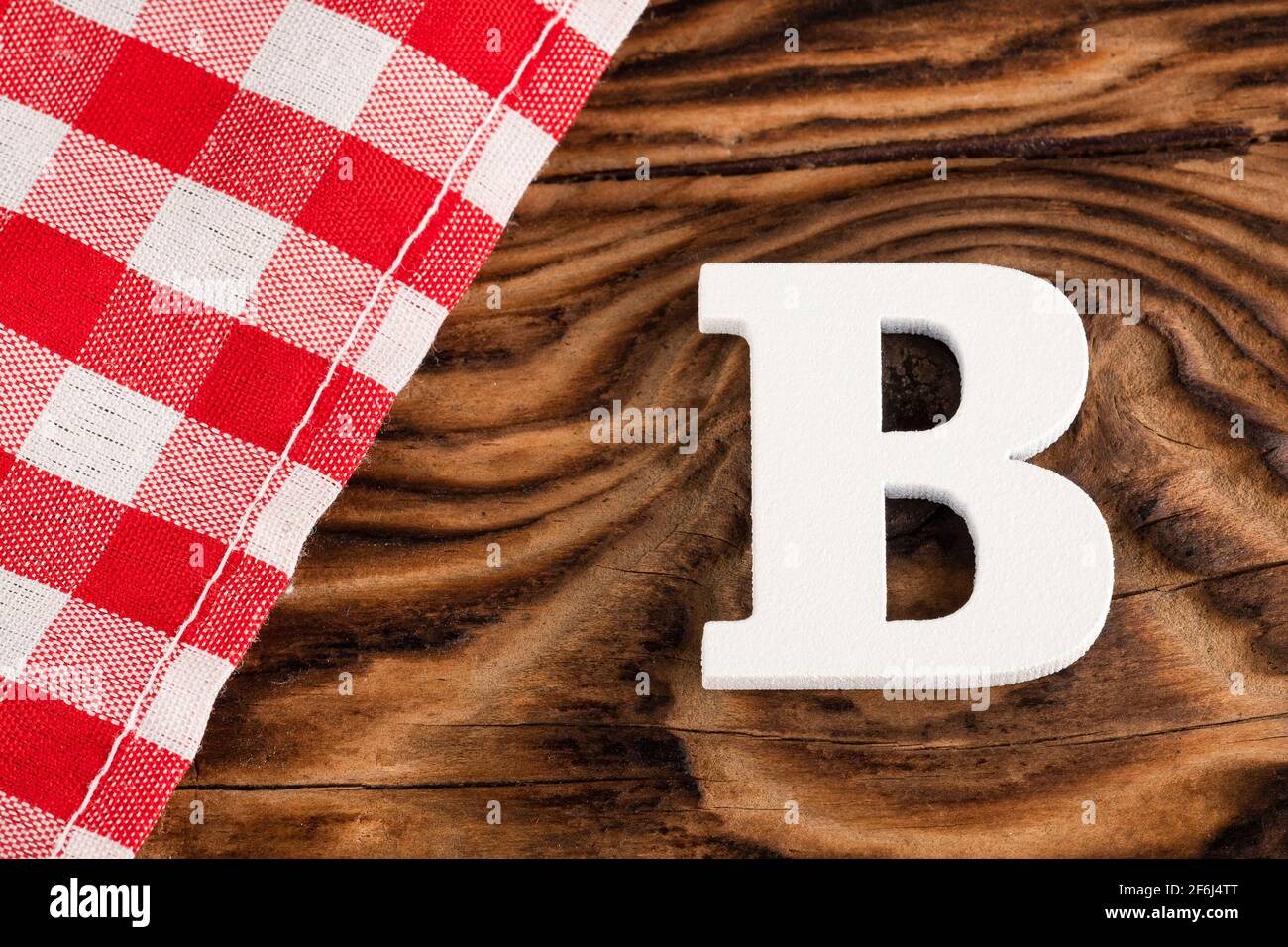 Letter B of the alphabet - Red checkered cloth tablecloth on rustic ...