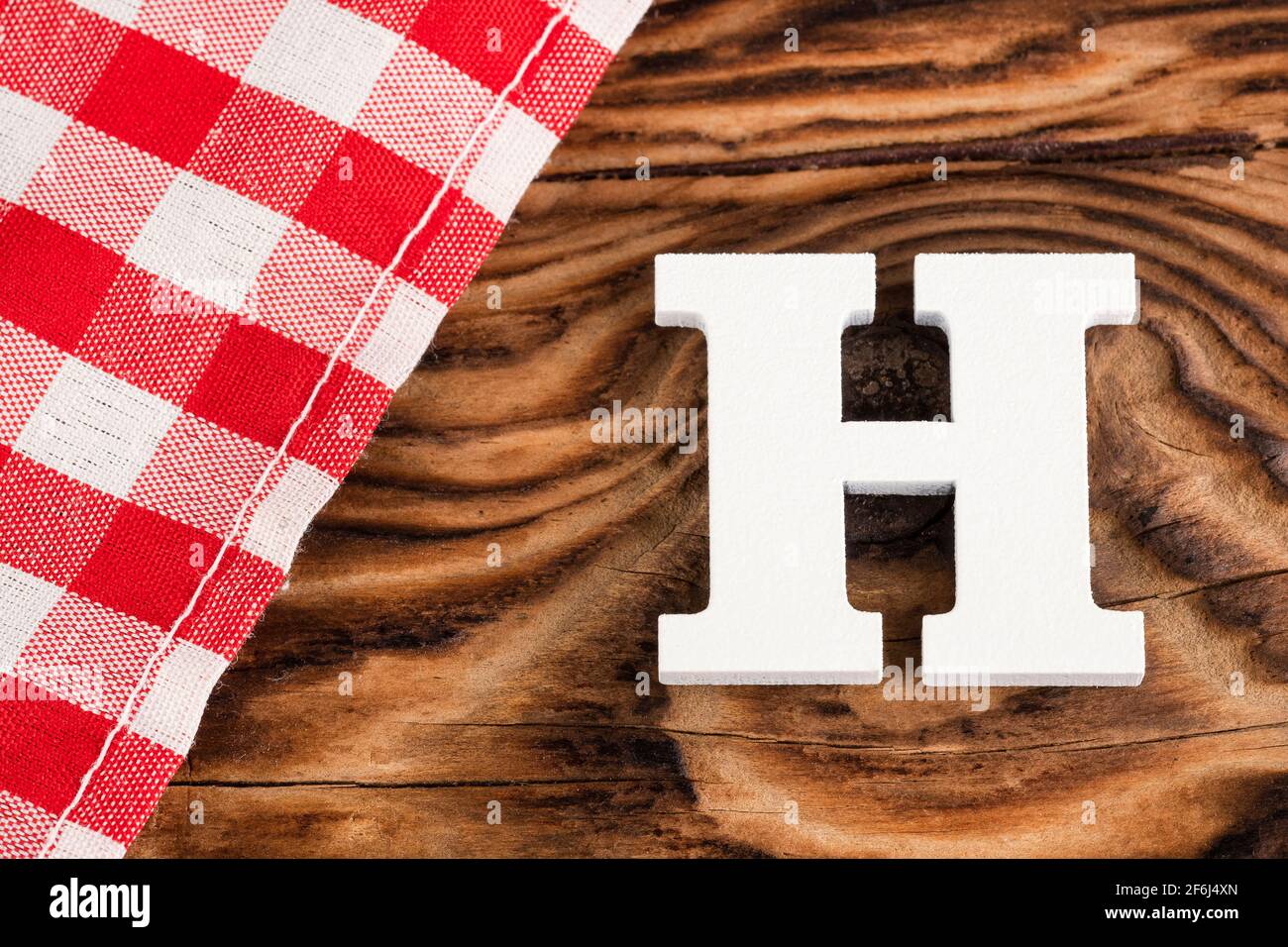 Letter H of the alphabet - Red checkered cloth tablecloth on rustic ...