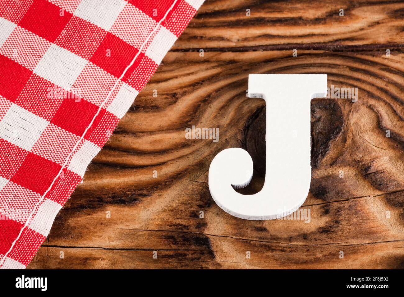 Letter J of the alphabet - Red checkered cloth tablecloth on rustic ...