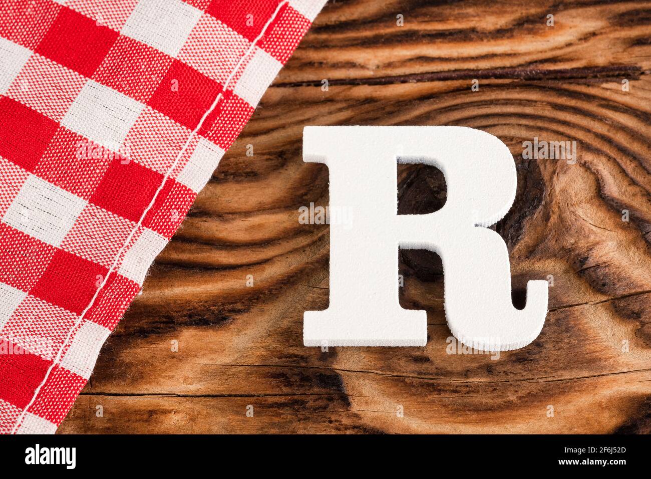 Letter R of the alphabet - Red checkered cloth tablecloth on rustic ...