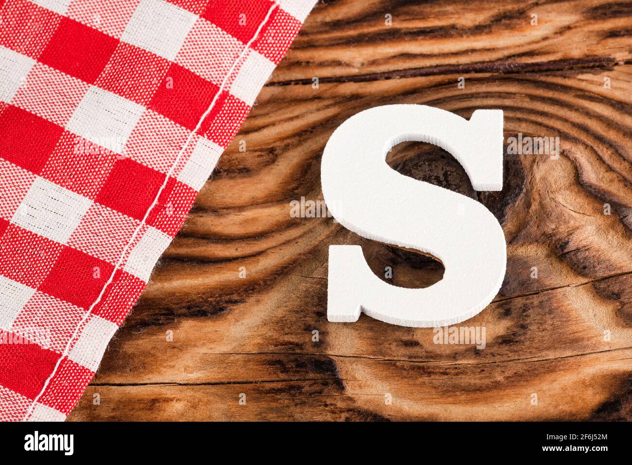Letter S of the alphabet - Red checkered cloth tablecloth on rustic ...