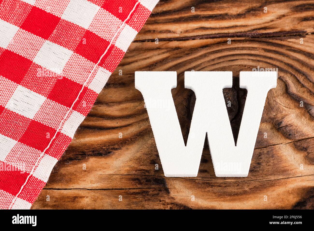 Letter W of the alphabet - Red checkered cloth tablecloth on rustic ...