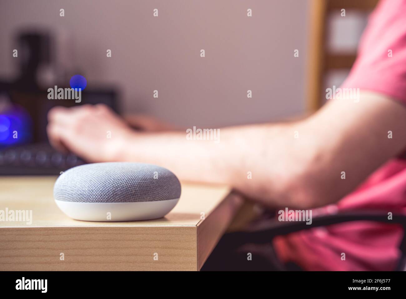 voice controlled smart speaker in a interior. male working in ...