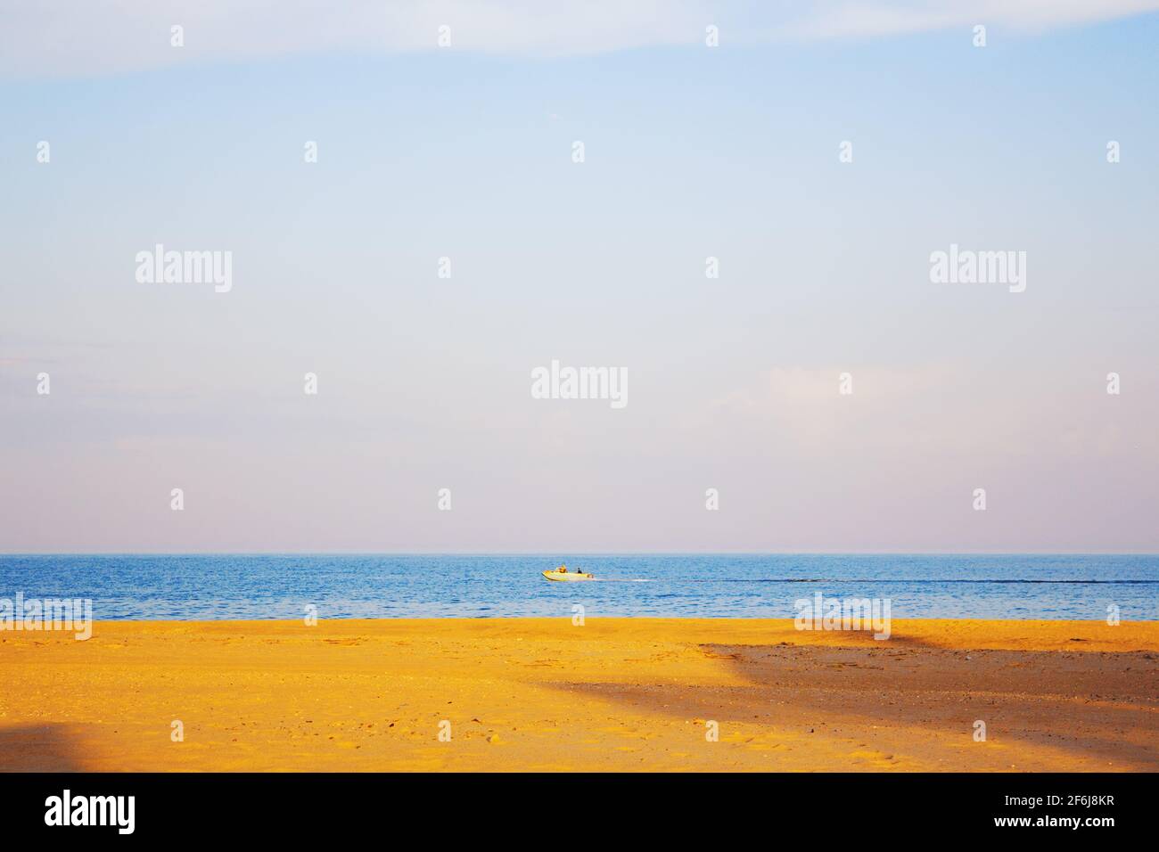 Sailing boat view from the sandy beach Stock Photo - Alamy